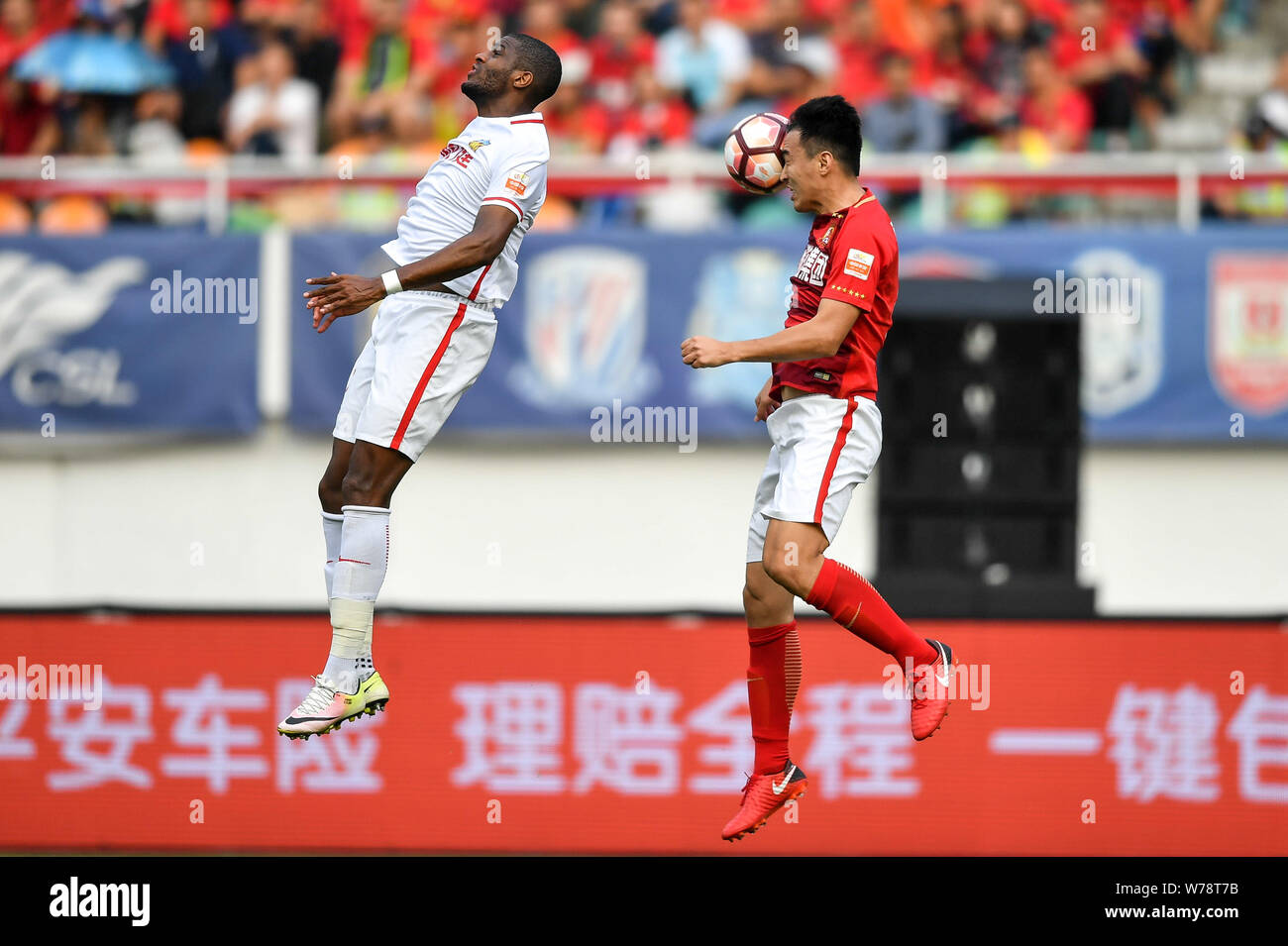 French football player Anthony Modeste, left, of Tianjin Quanjian heads ...