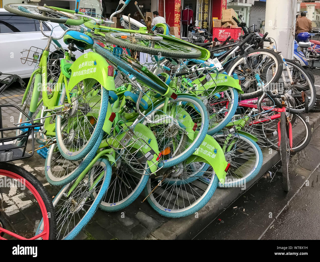 Bicycles of Chinese bike-sharing service Kuqi (green) are piled up on a ...