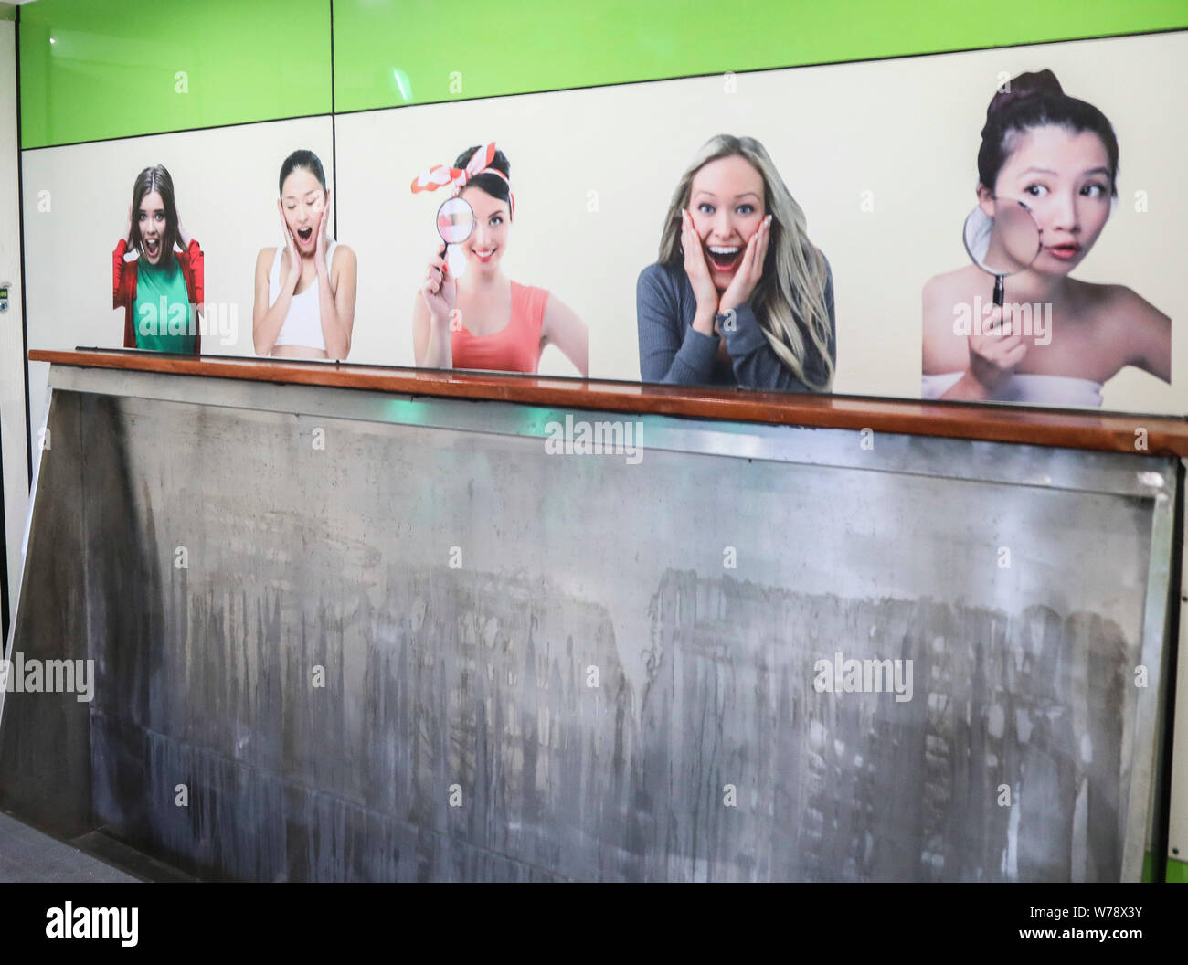 View of pictures of beautiful women pasted on the wall beside the ...