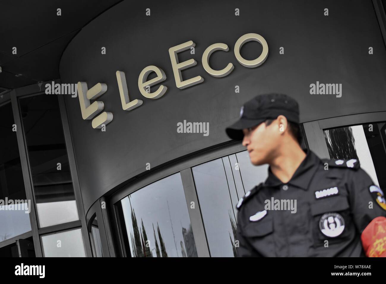 --FILE--A police officer stands guard in front of the Beijing ...