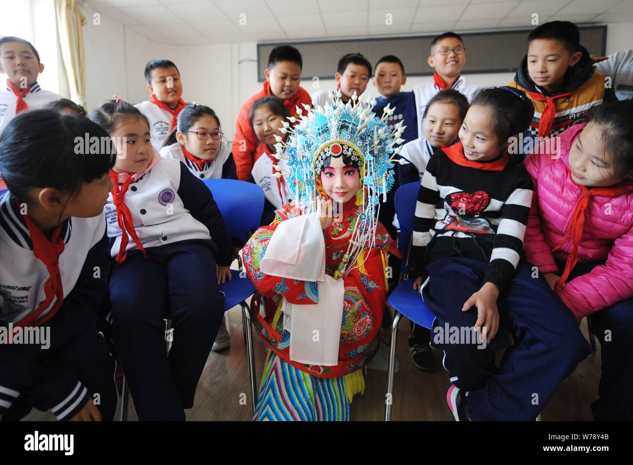 A primary student poses after finishing her hair and makeup dressed as ...