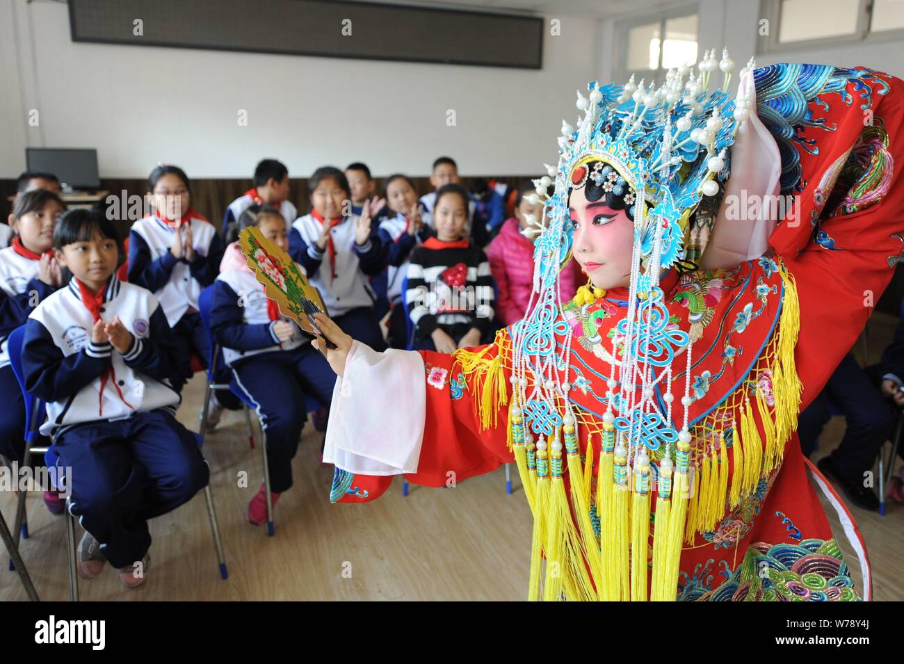 A primary student practices after finishing her hair and makeup dressed ...