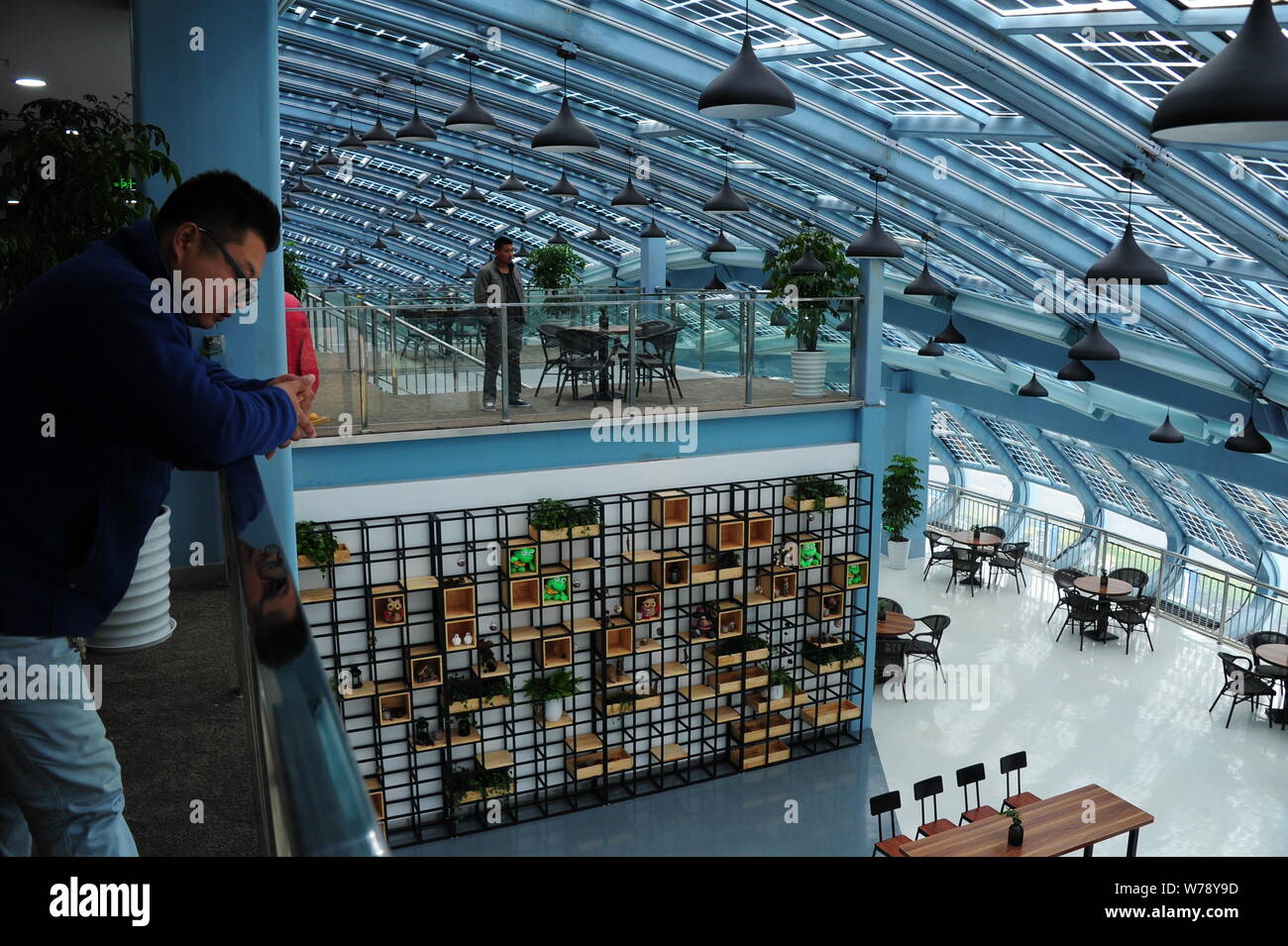A local resident waits in the China's largest solar photovoltaic super charging station of ...