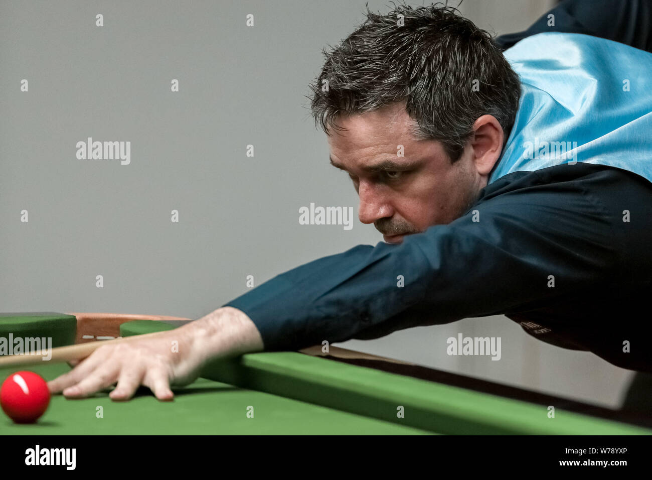 Alan McManus of Scotland plays a shot to Dominic Dale of Wales in their ...