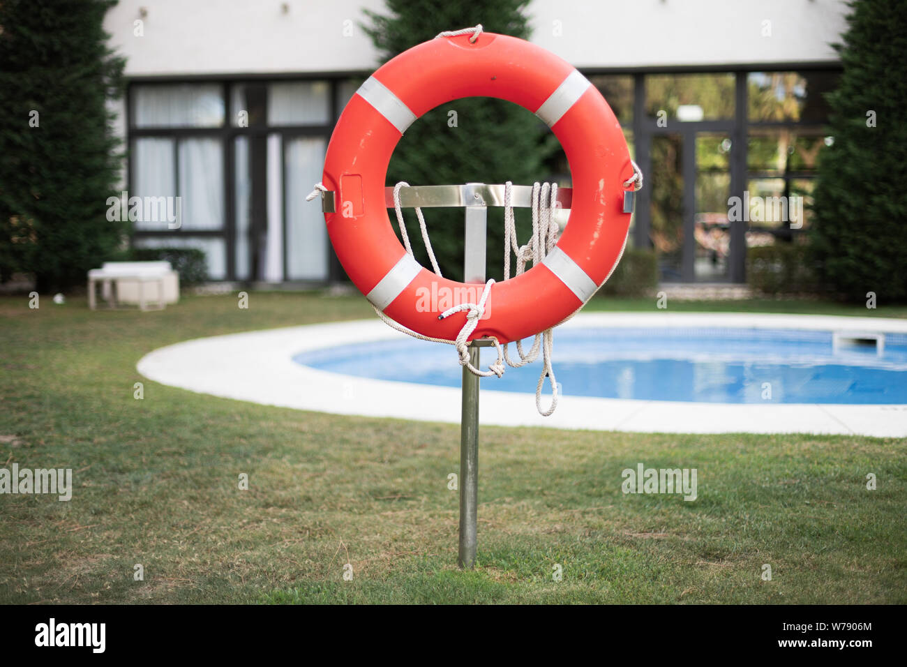 Close up photo of an orange and white rubber lifesaver float, standing ...