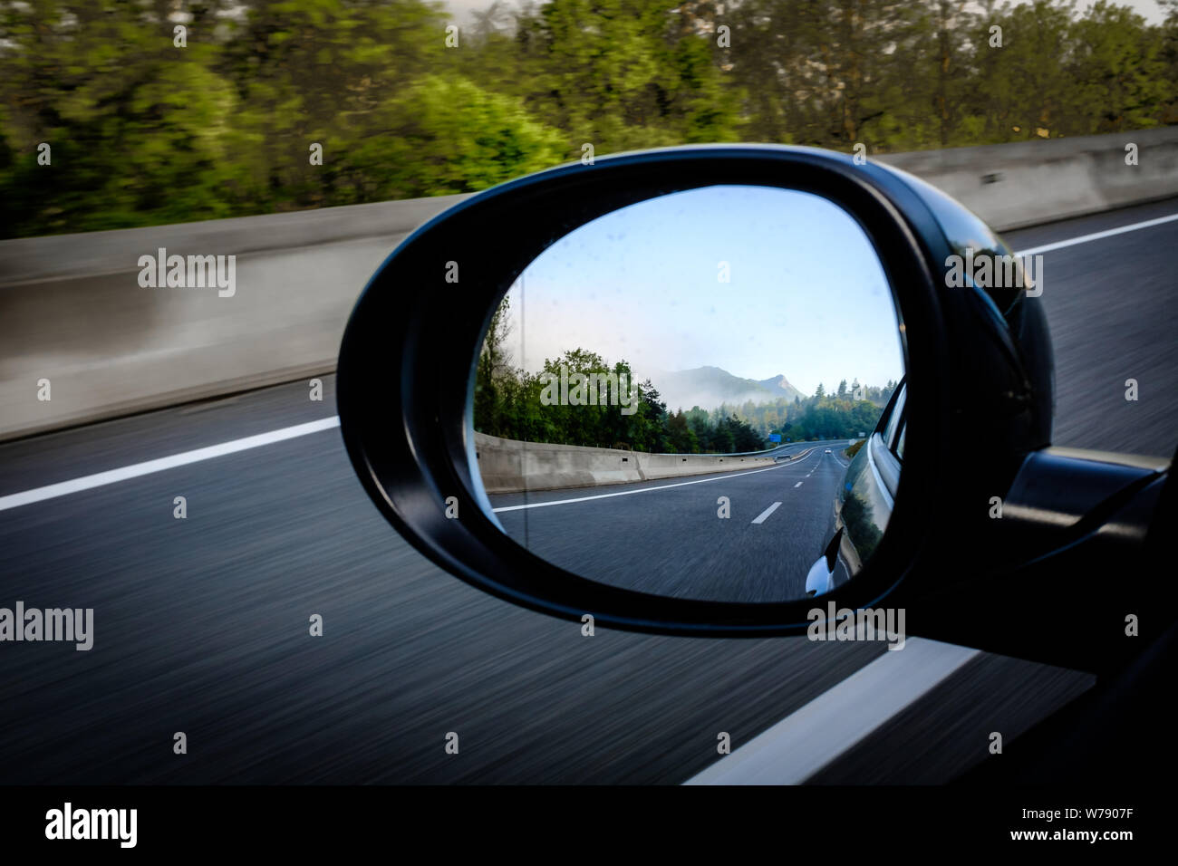 Oval mirror car reflection driving on a highway Stock Photo - Alamy