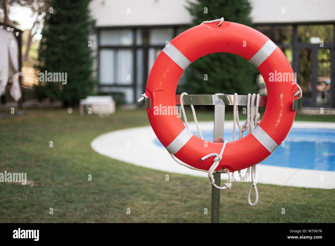 Close up photo of an orange and white rubber lifesaver float, standing ...