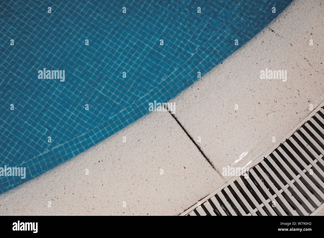 Blue tiled floor of a swimming pool with water and flow in it Stock ...