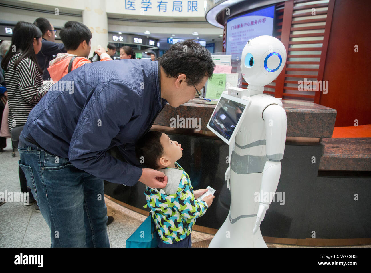 Patients use the smart robot, named Xiaoman, working as a receptionist ...