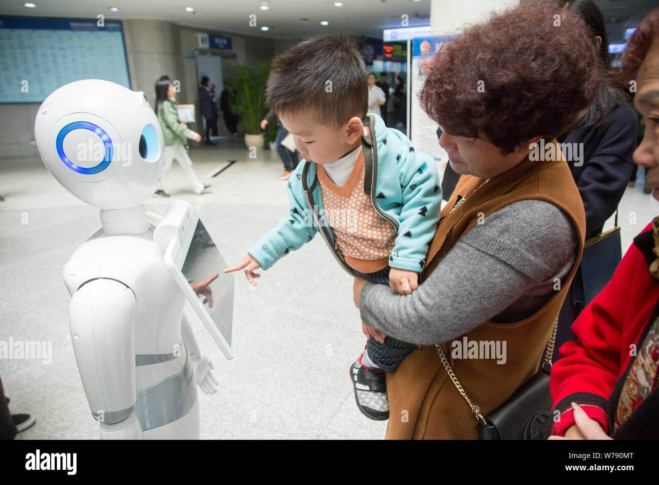 Patients use the smart robot, named Xiaoman, working as a receptionist ...