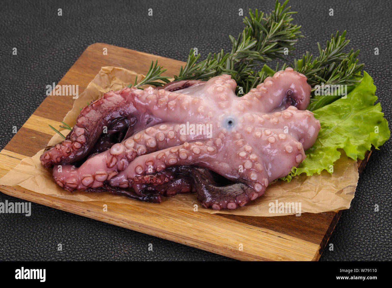 Raw octopus ready for cooking with rosemary Stock Photo - Alamy