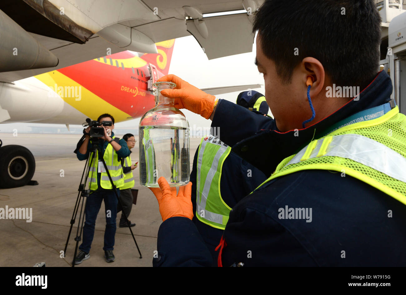 A Chinese ground crew member refuels a jet plane Boeing 787 Dreamliners ...