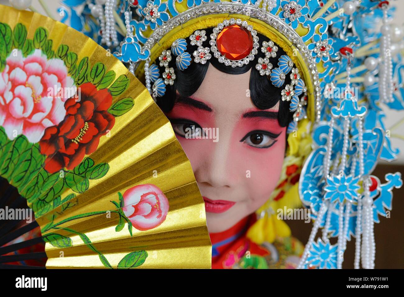 A primary student poses after finishing her hair and makeup dressed as ...