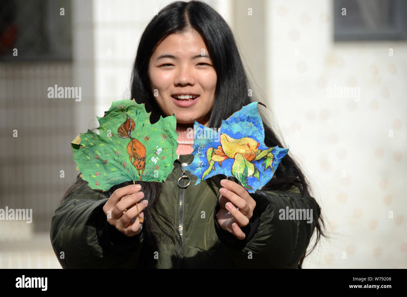Chinese student Li Ling shows different pictures bearing symbols of the ...