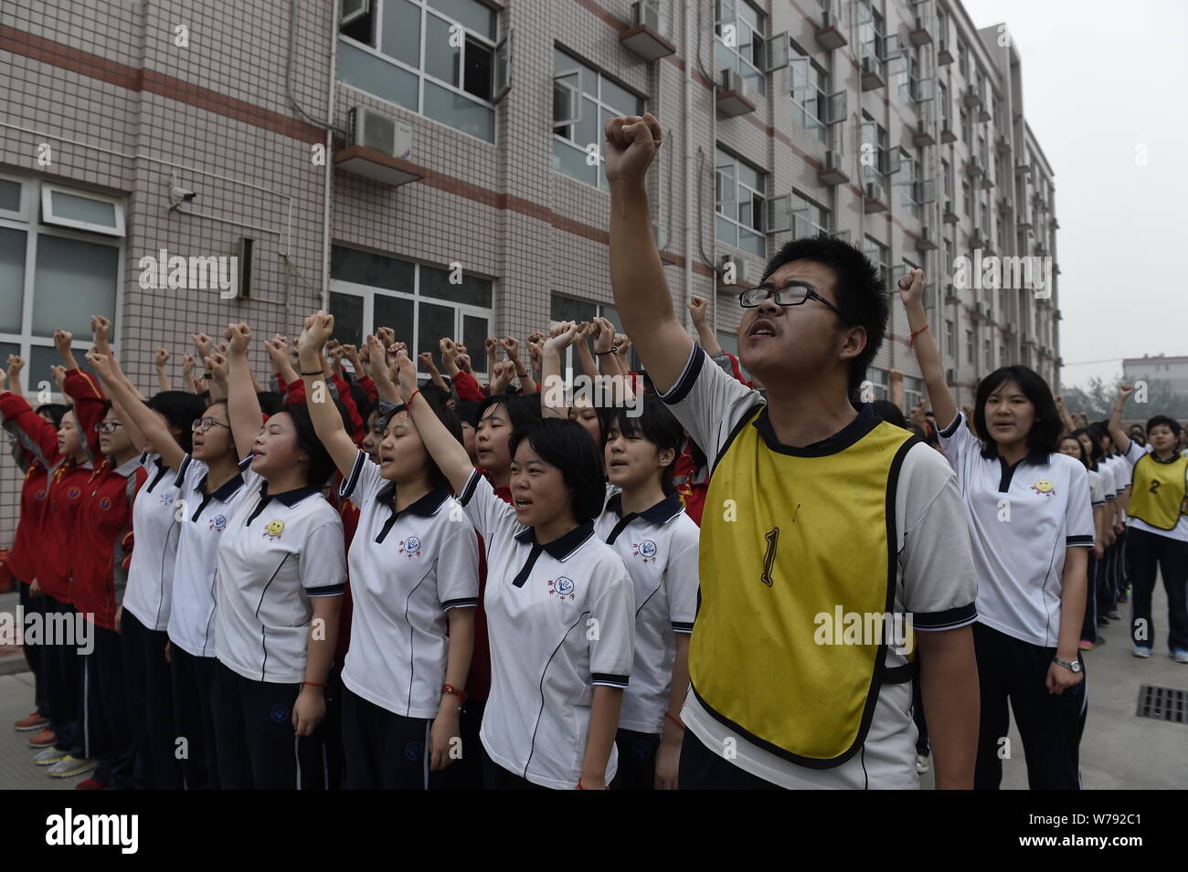 Chinese students shout slogans before doing morning reading at Jingying ...