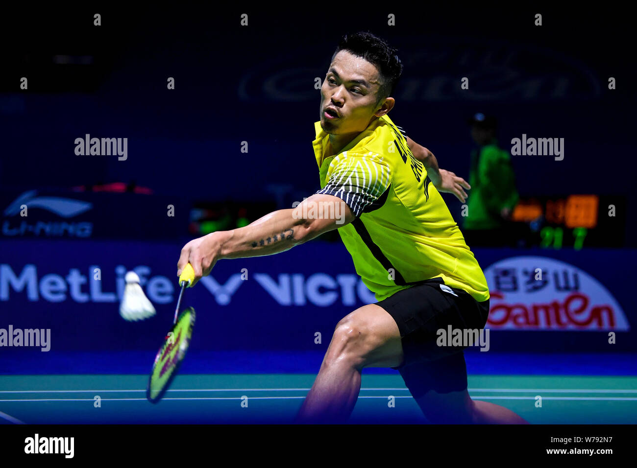 Lin Dan of China returns a shot to Christie Jonatan of Indonesia in ...