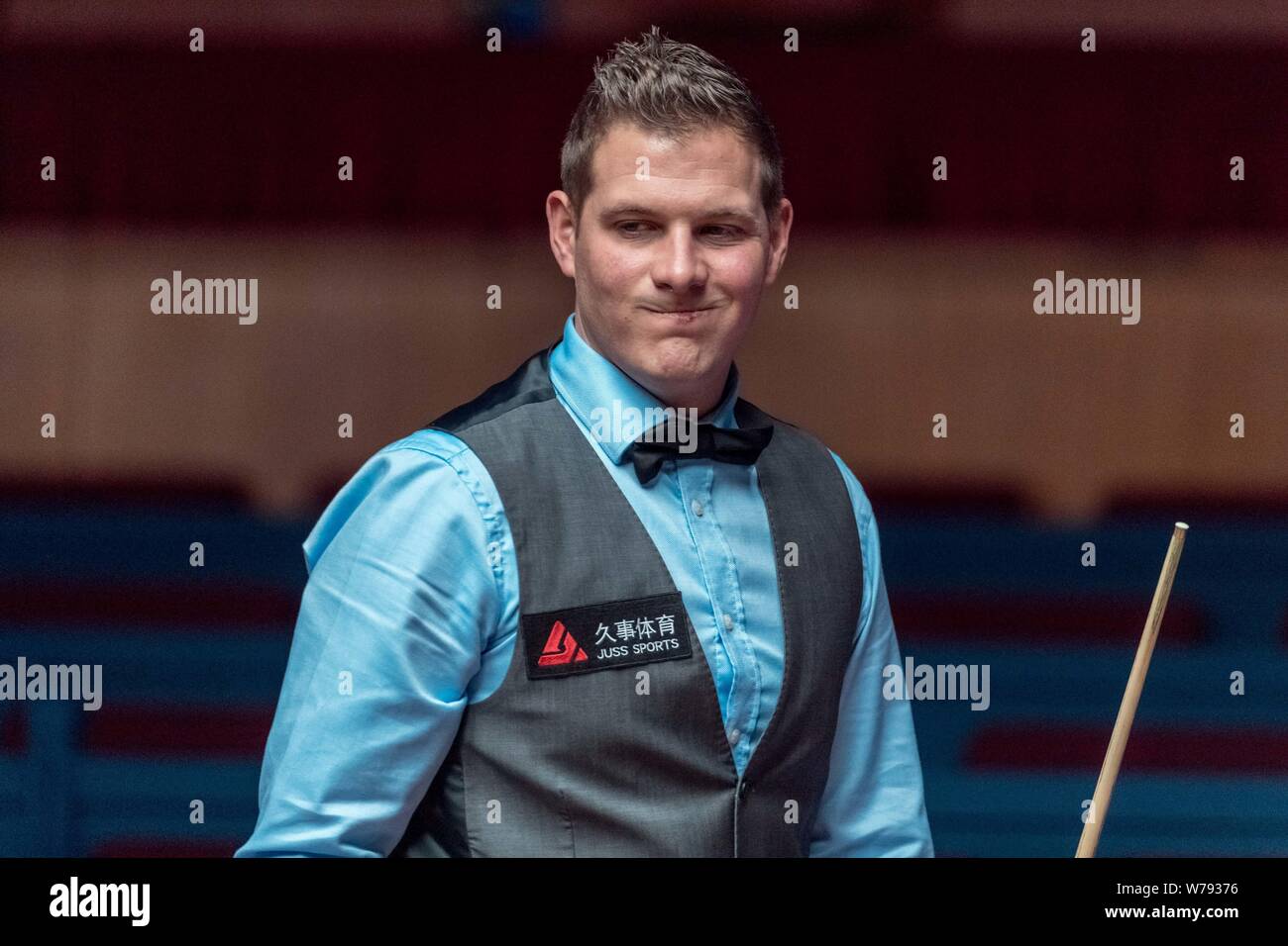 Barry Hawkins of England reacts as he considers a shot to Daniel Wells ...