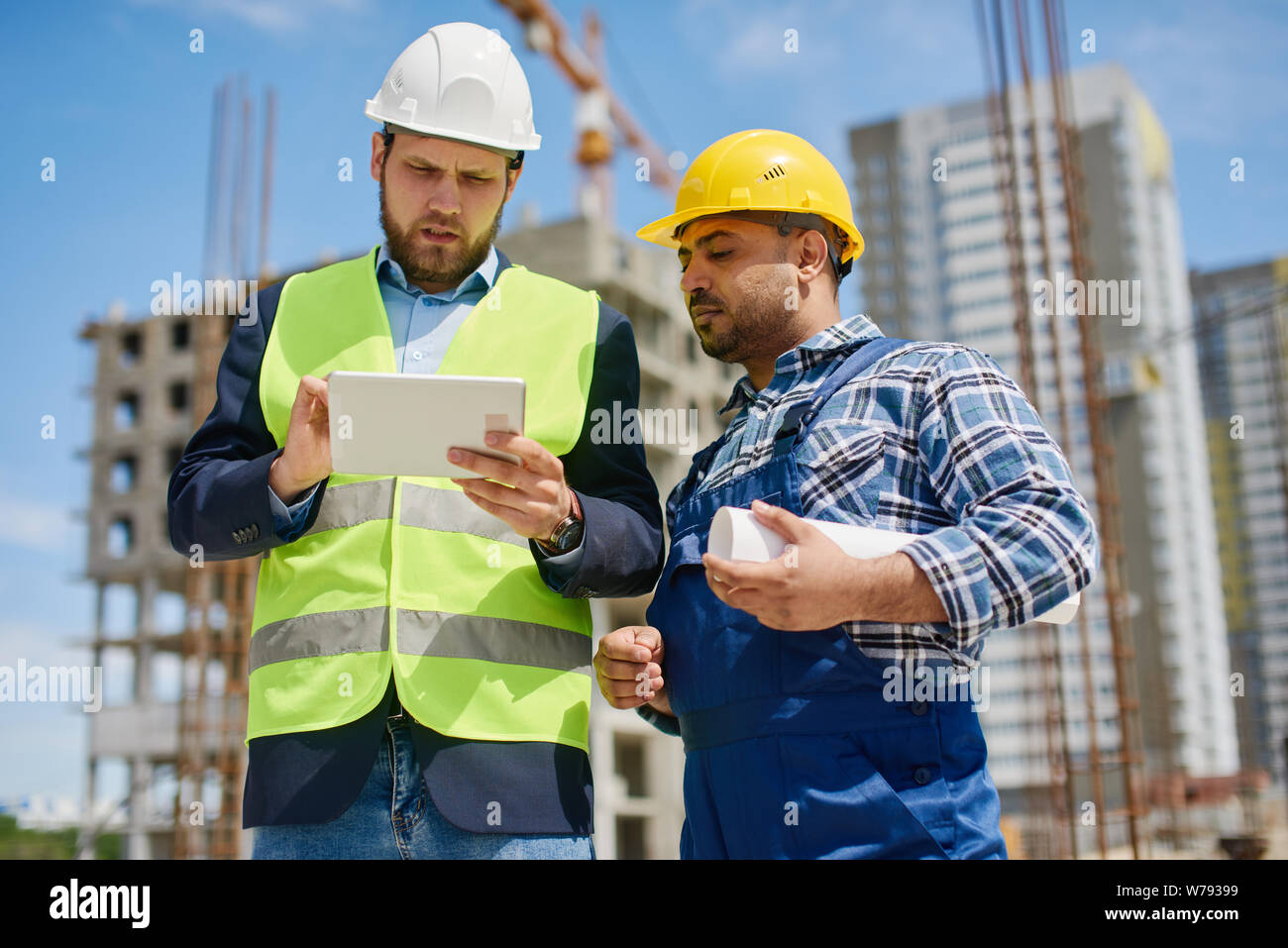 Two engineers discuss work related questions together Stock Photo - Alamy