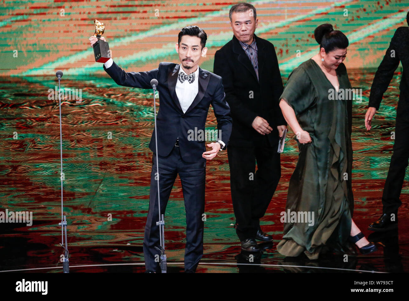 **TAIWAN OUT**Taiwanese actor Chen Chu-sheng holds up his trophy of the ...