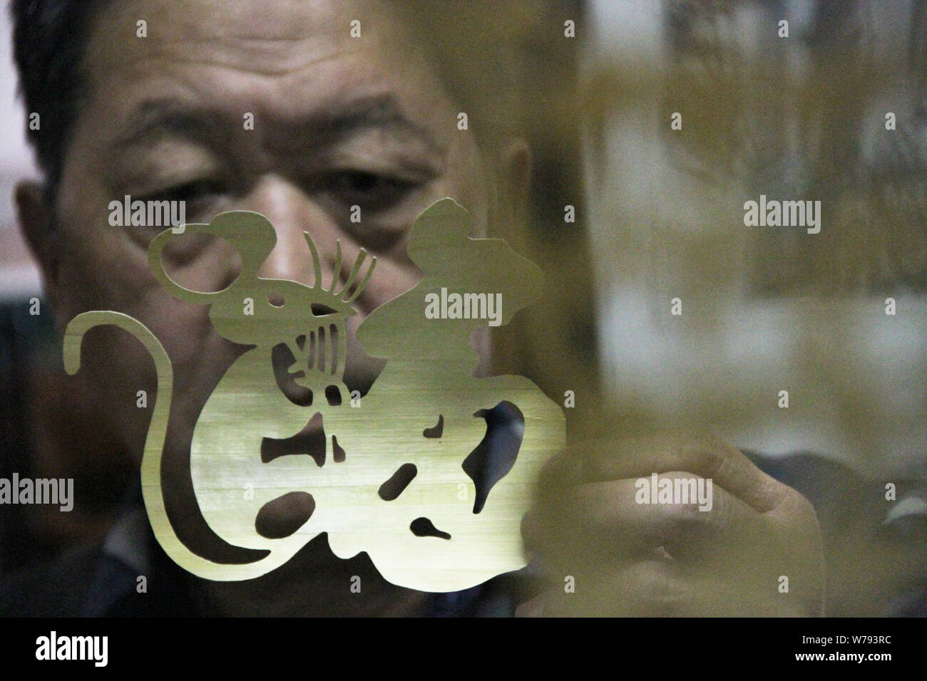 67-year-old Chinese man Zhang Chongsheng shows a Chinese character "Fu ...