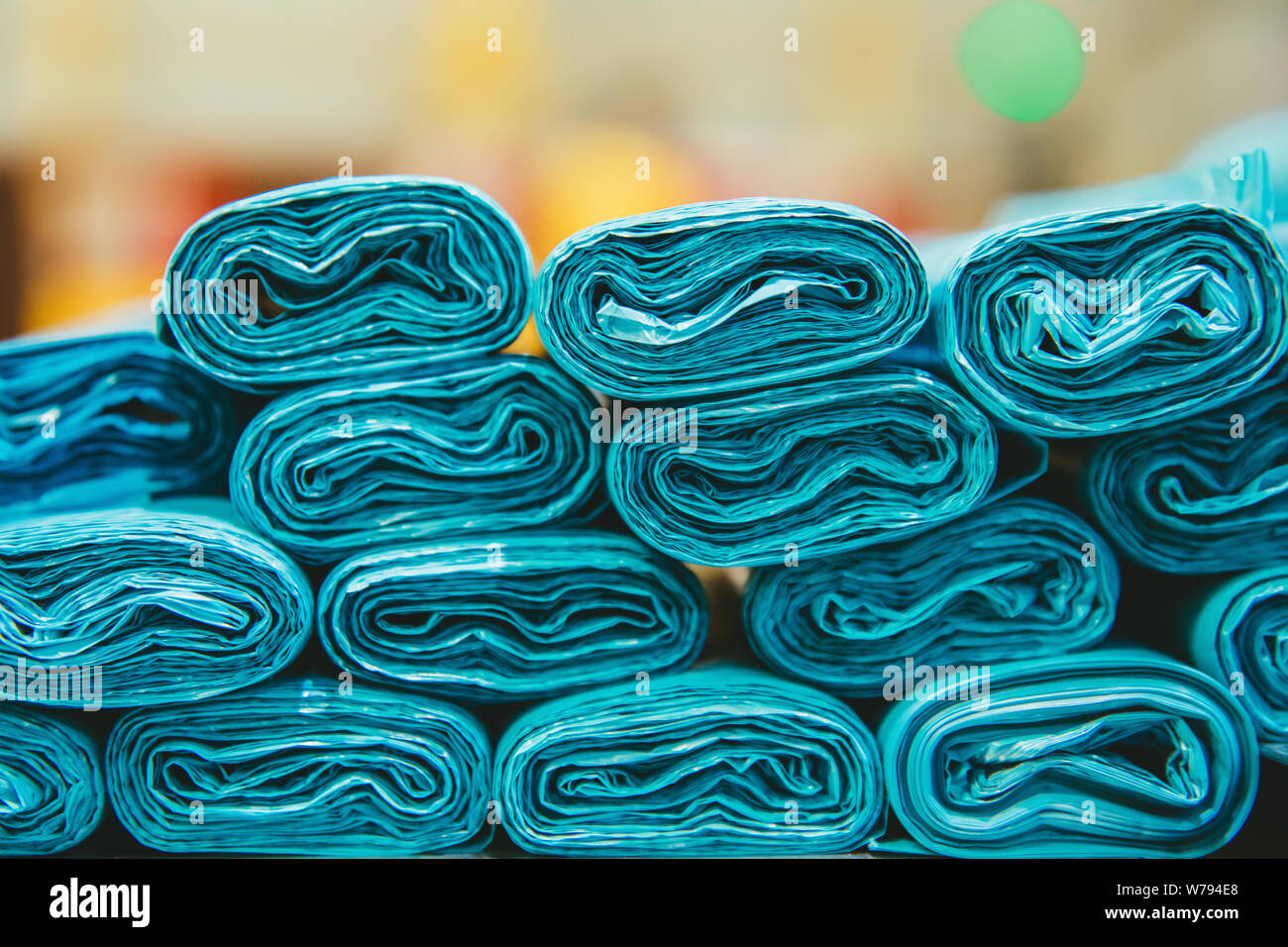 Pile or stack of Blue colored plastic garbage bag container rolls. Blue ...