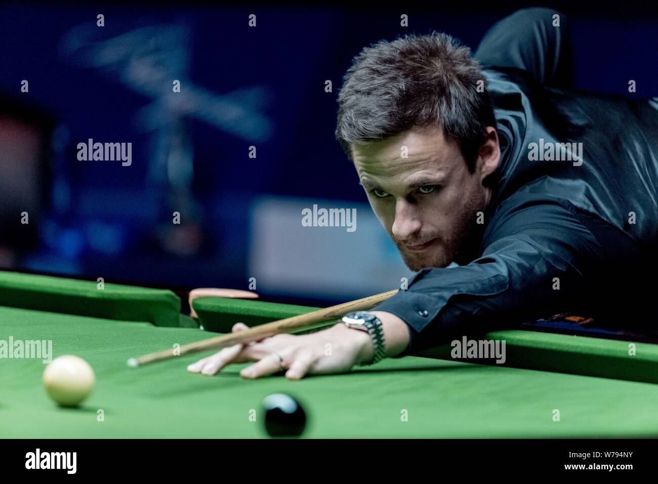 David Gilbert of England plays a shot to Liang Wenbo of China in their ...
