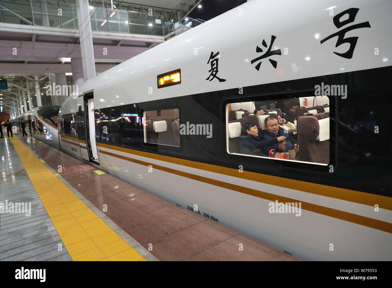 Passengers sit in a "Fuxing" high speed bullet train on Beijing ...