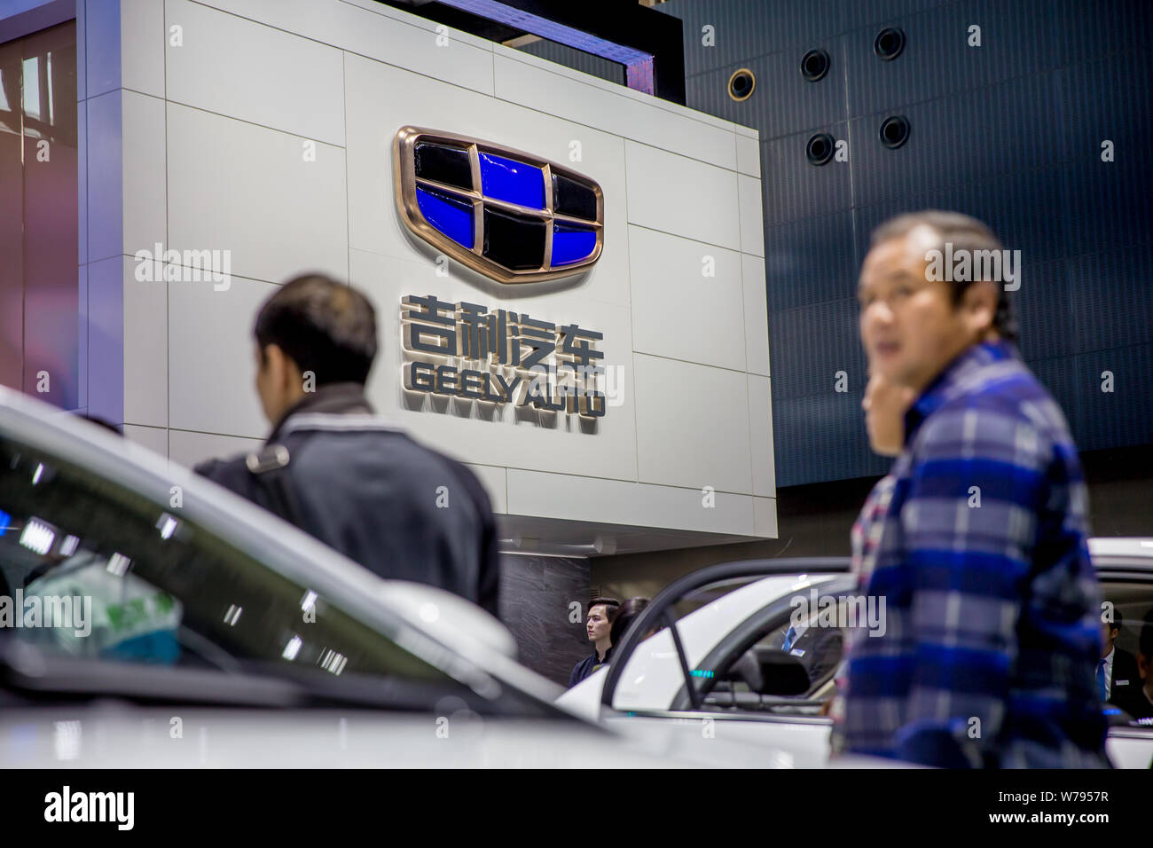 --FILE--People visit the stand of Geely during the 15th China ...