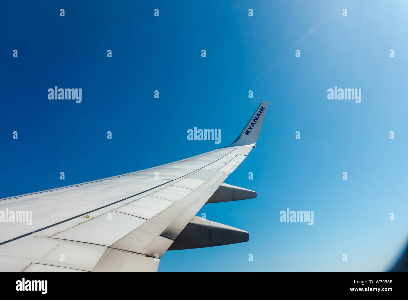 view of a Ryanair Boeing 737 - 800 wing out of plane window in flight ...