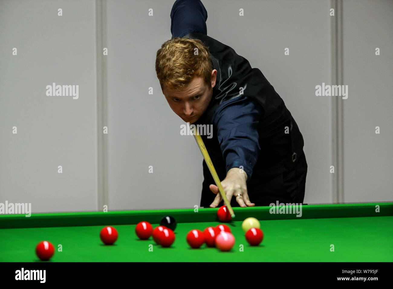 Ben Woollaston of England plays a shot to Michael Georgiou of England ...