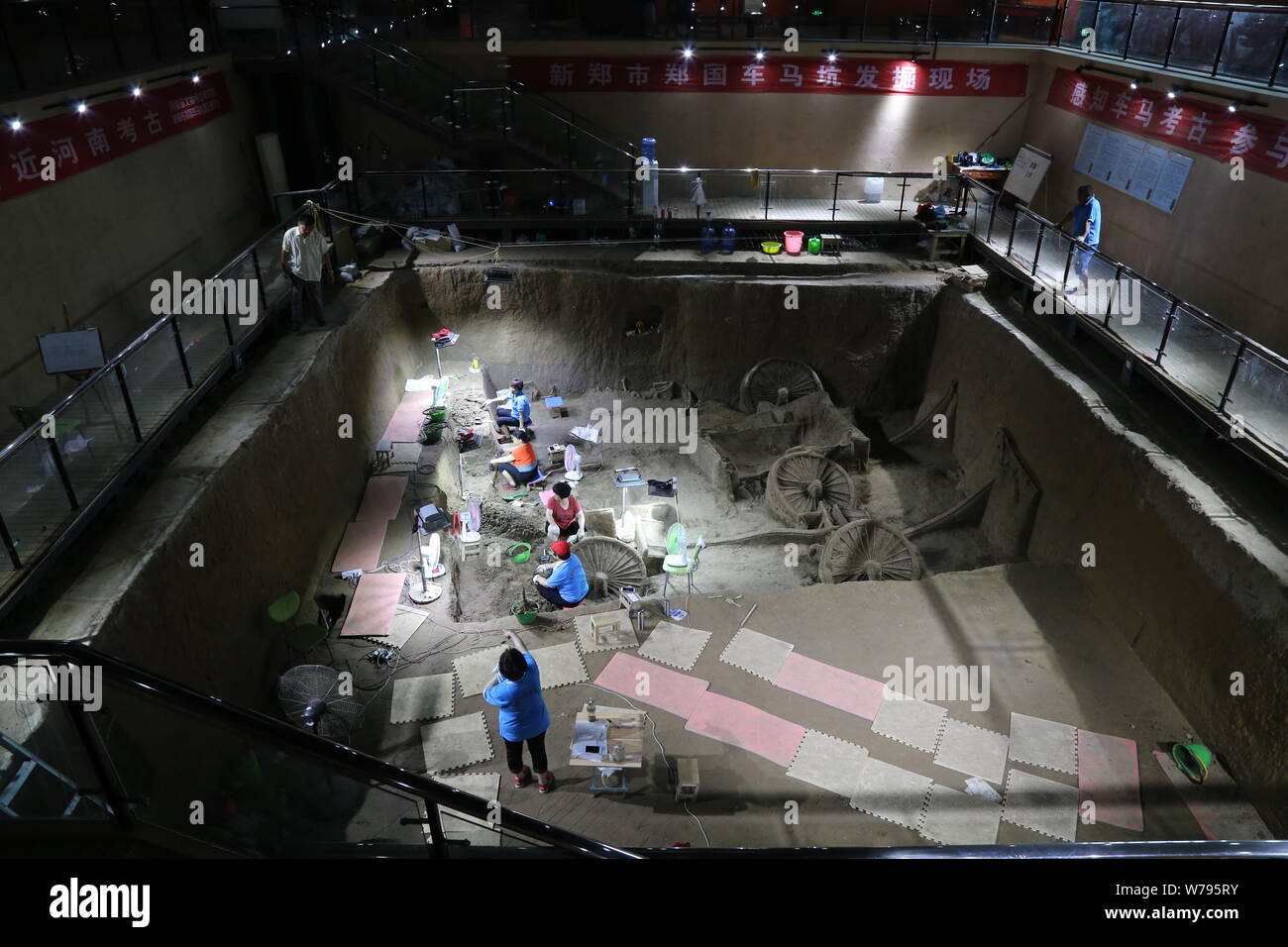 --FILE--Chinese workers excavate a 2,400-year-old pit containing horses ...