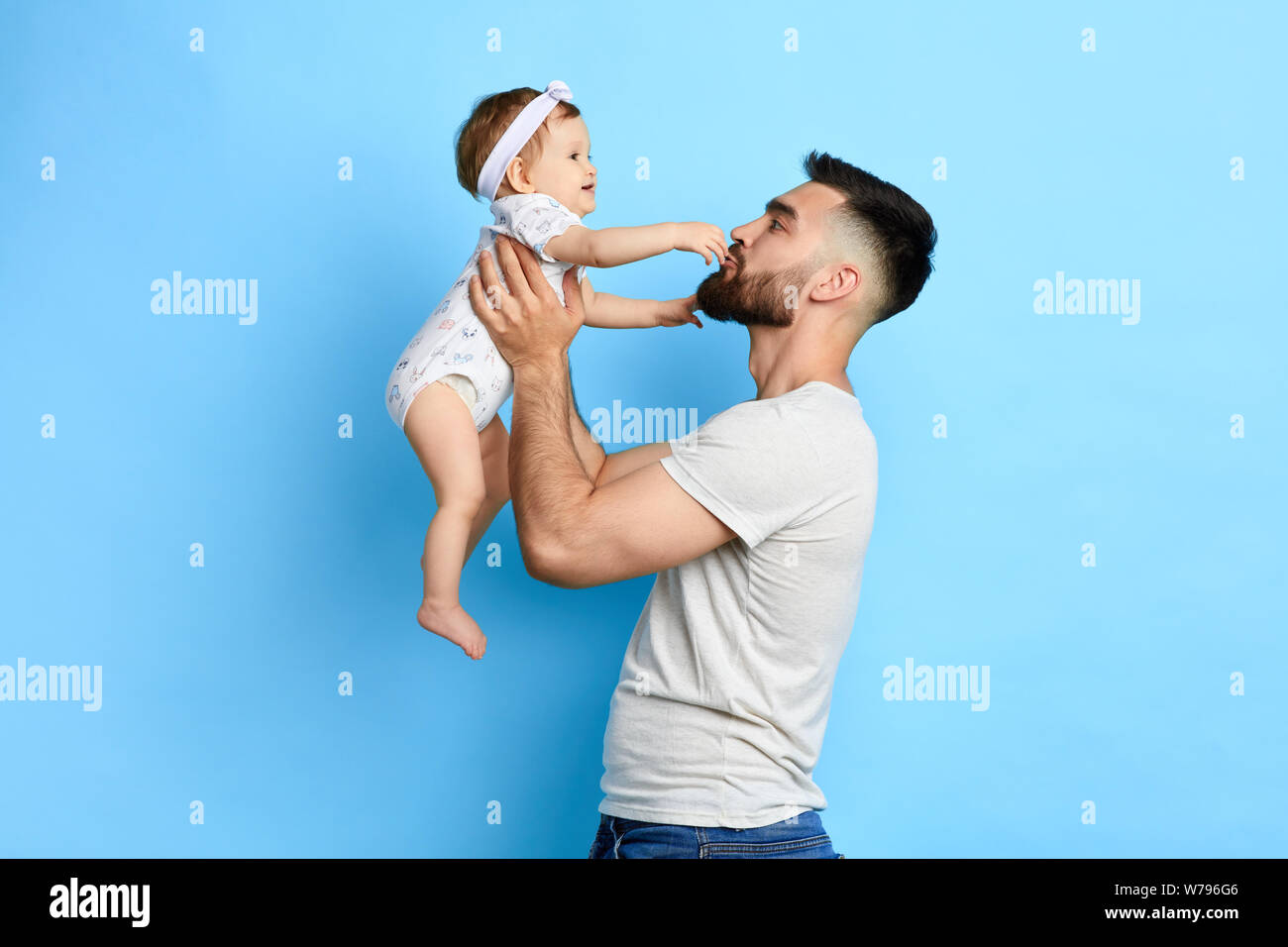 young dad singing songs to his adorable baby. close up side view photo ...