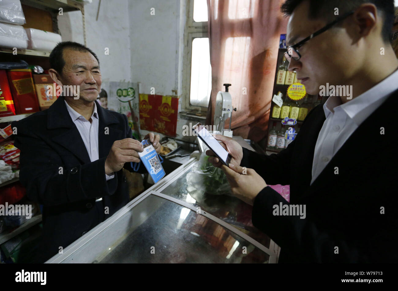 A customer scans a QR code through Chinese online payment service ...