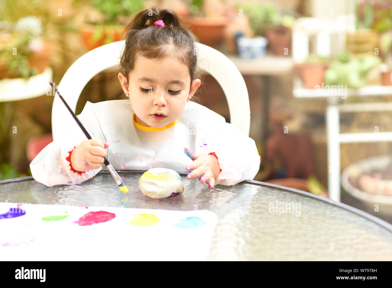 Cute little girl drawing at summer camp Stock Photo - Alamy