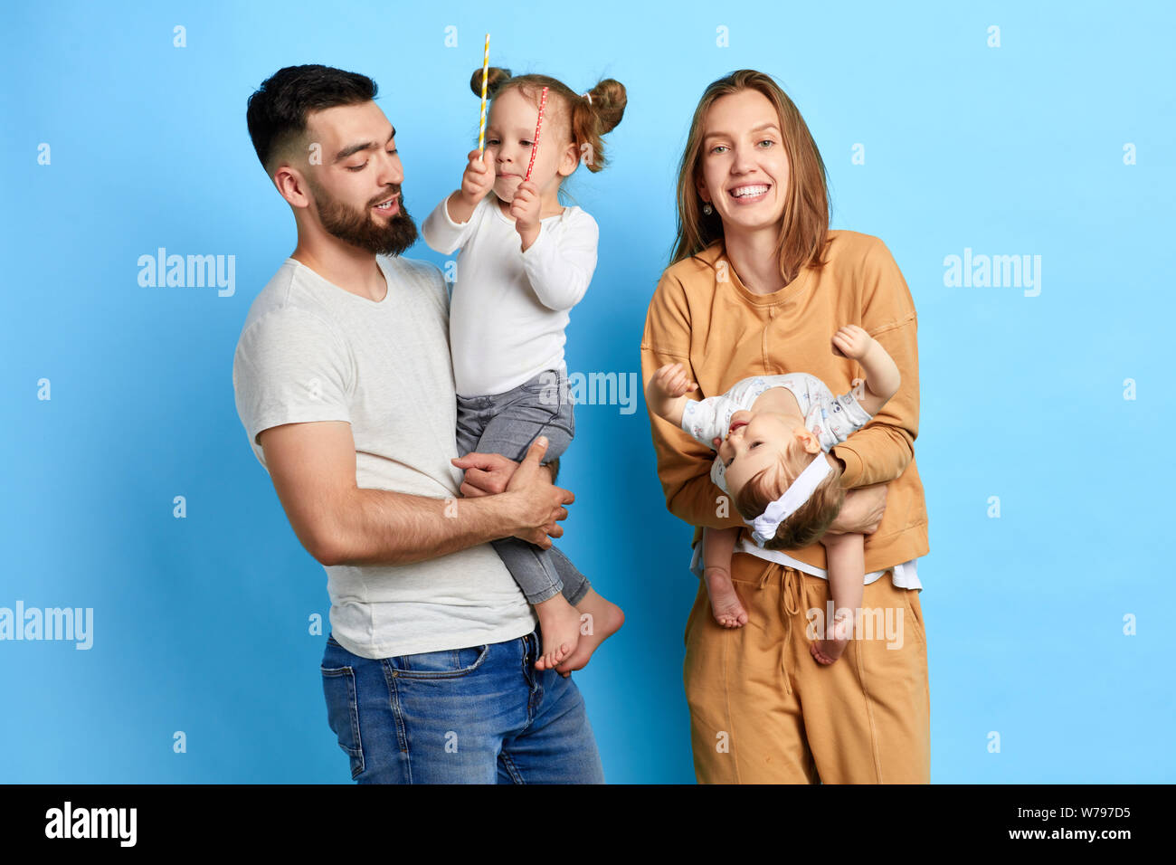 naughty children having fun with parents, happy parenthood.isolated ...