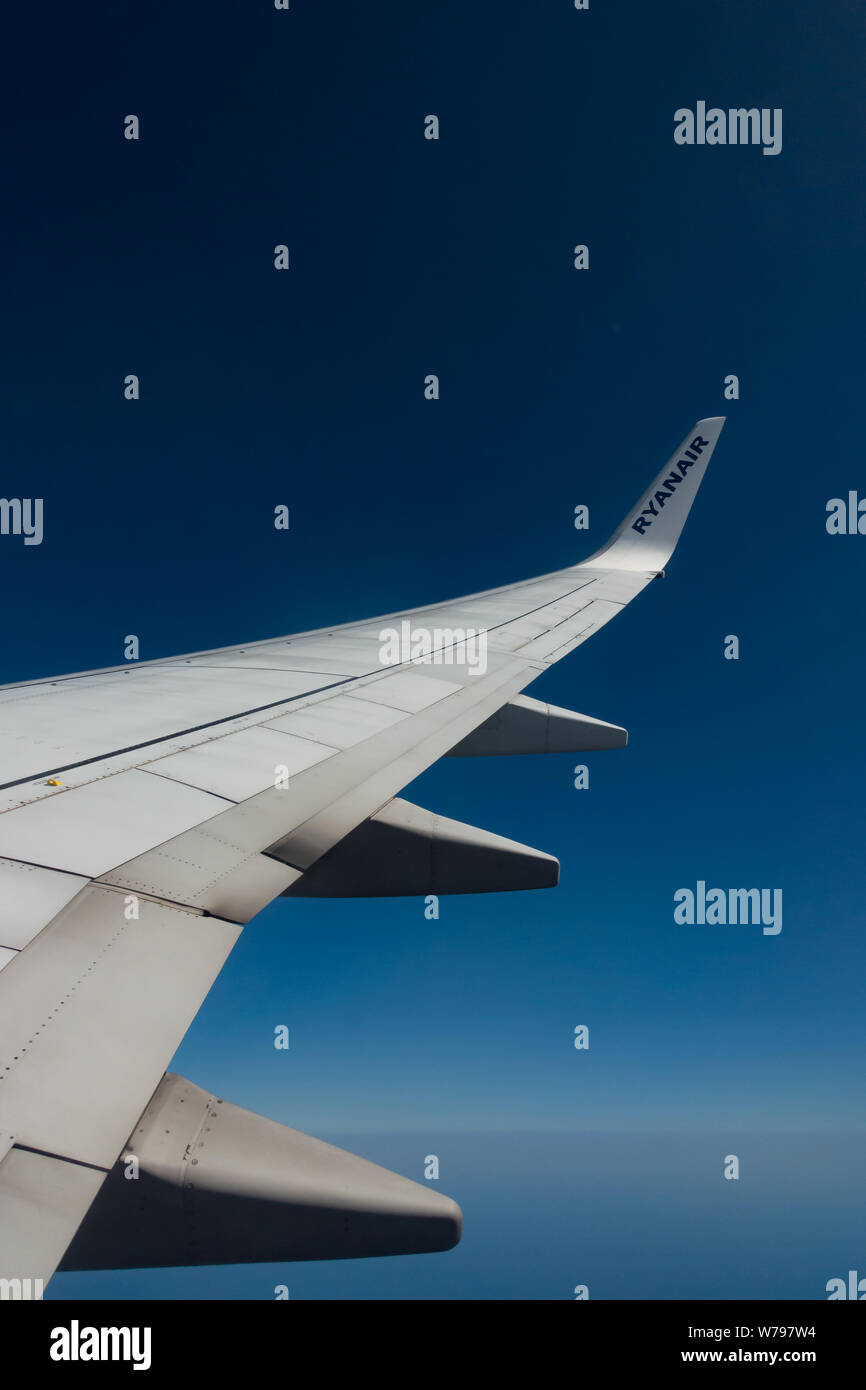 view of a Ryanair Boeing 737 - 800 wing out of plane window in flight ...