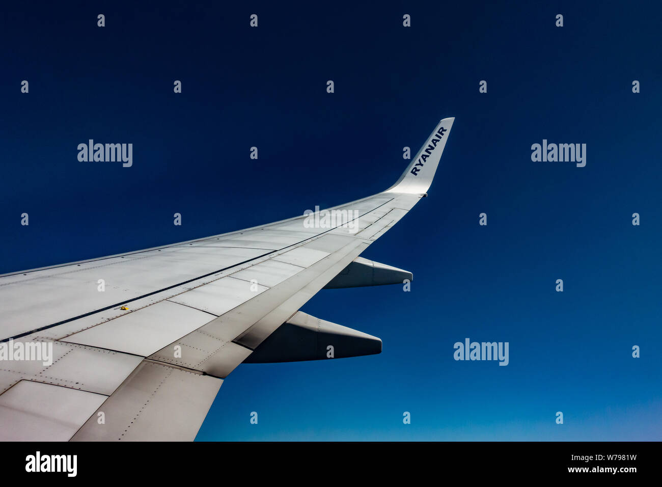 view of a Ryanair Boeing 737 - 800 wing out of plane window in flight ...
