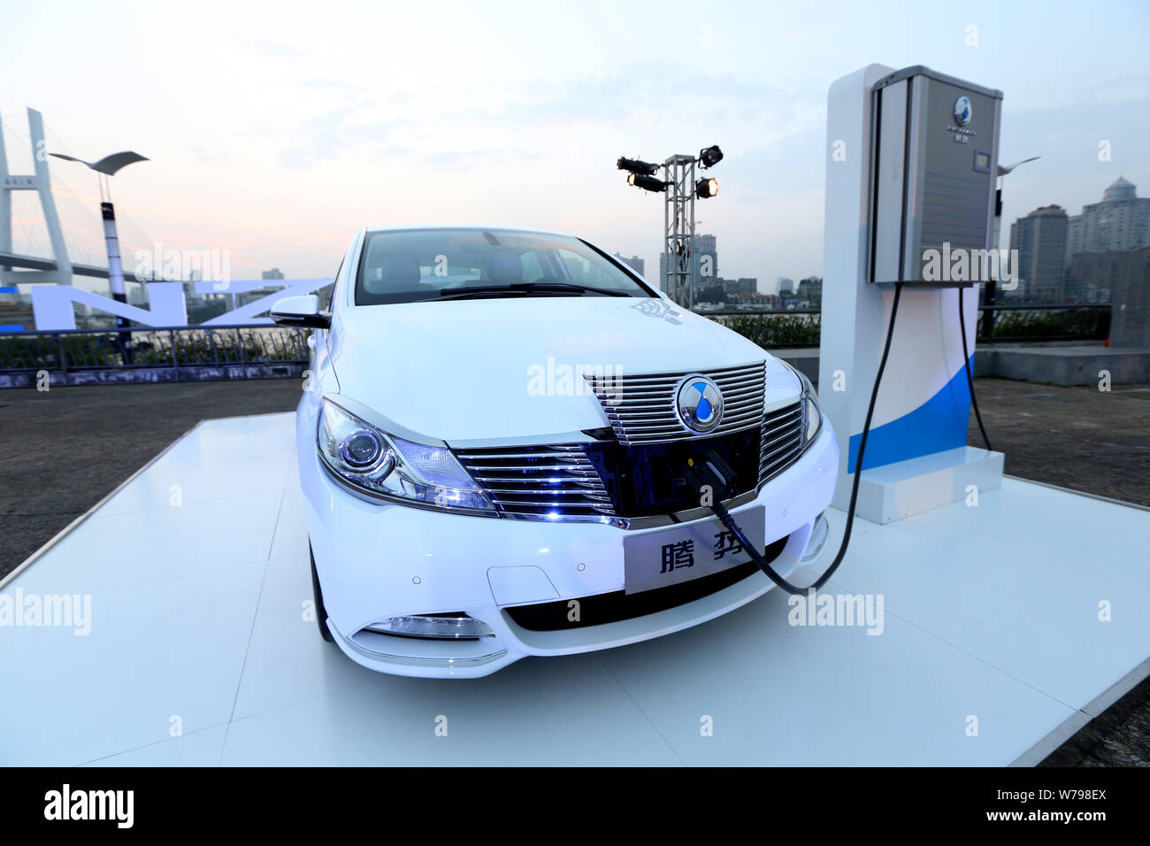 --FILE--A Denza electric vehicle (EV) is being recharged in front of a ...