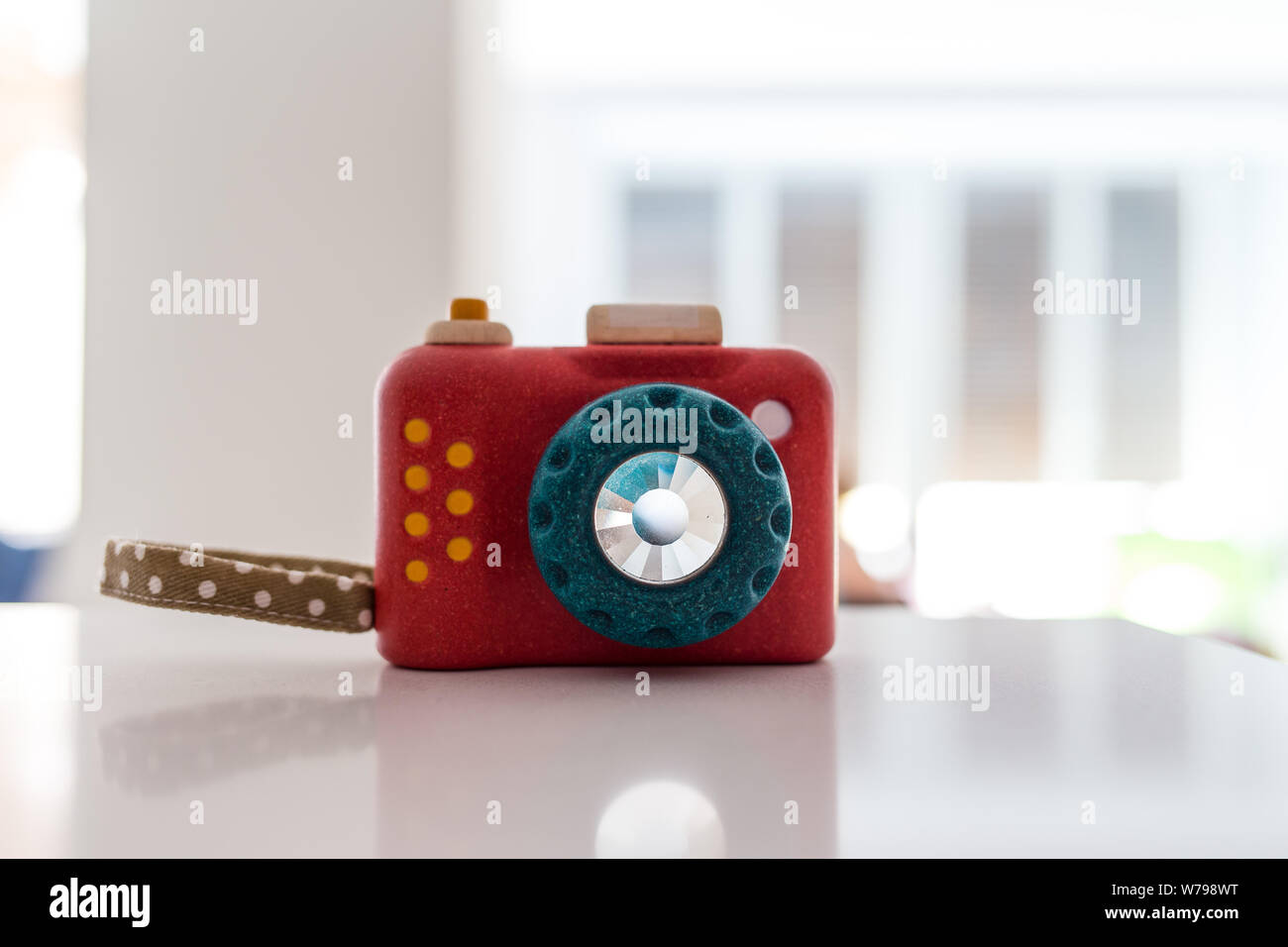 Red toy wooden toy camera on an indoor white scene Stock Photo - Alamy