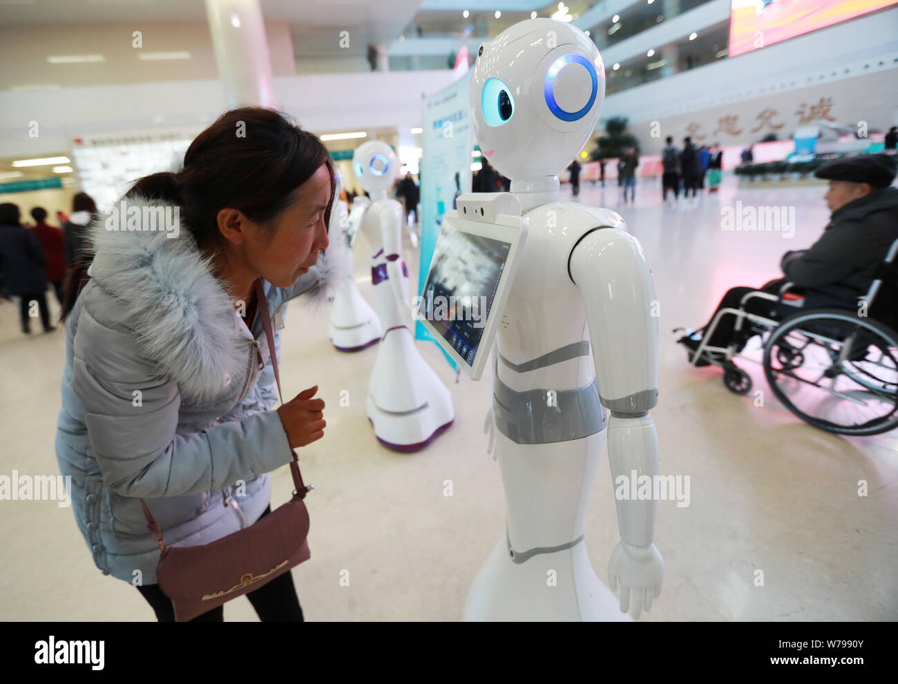 A robot provides information for a visitor at Chinese PLA General ...