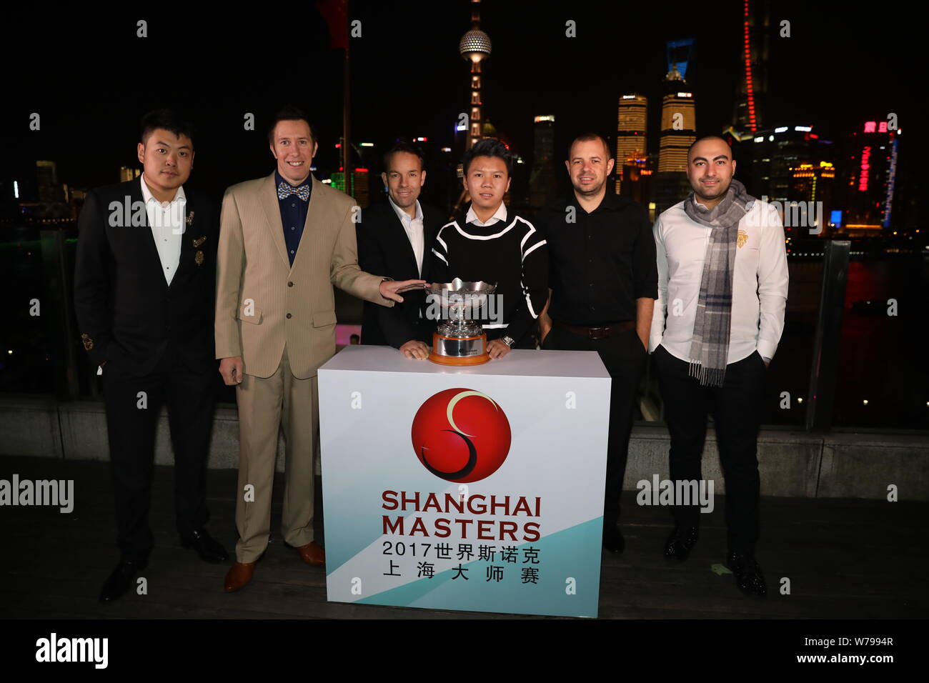 Dominic Dale of Wales and other snooker players show the champion ...