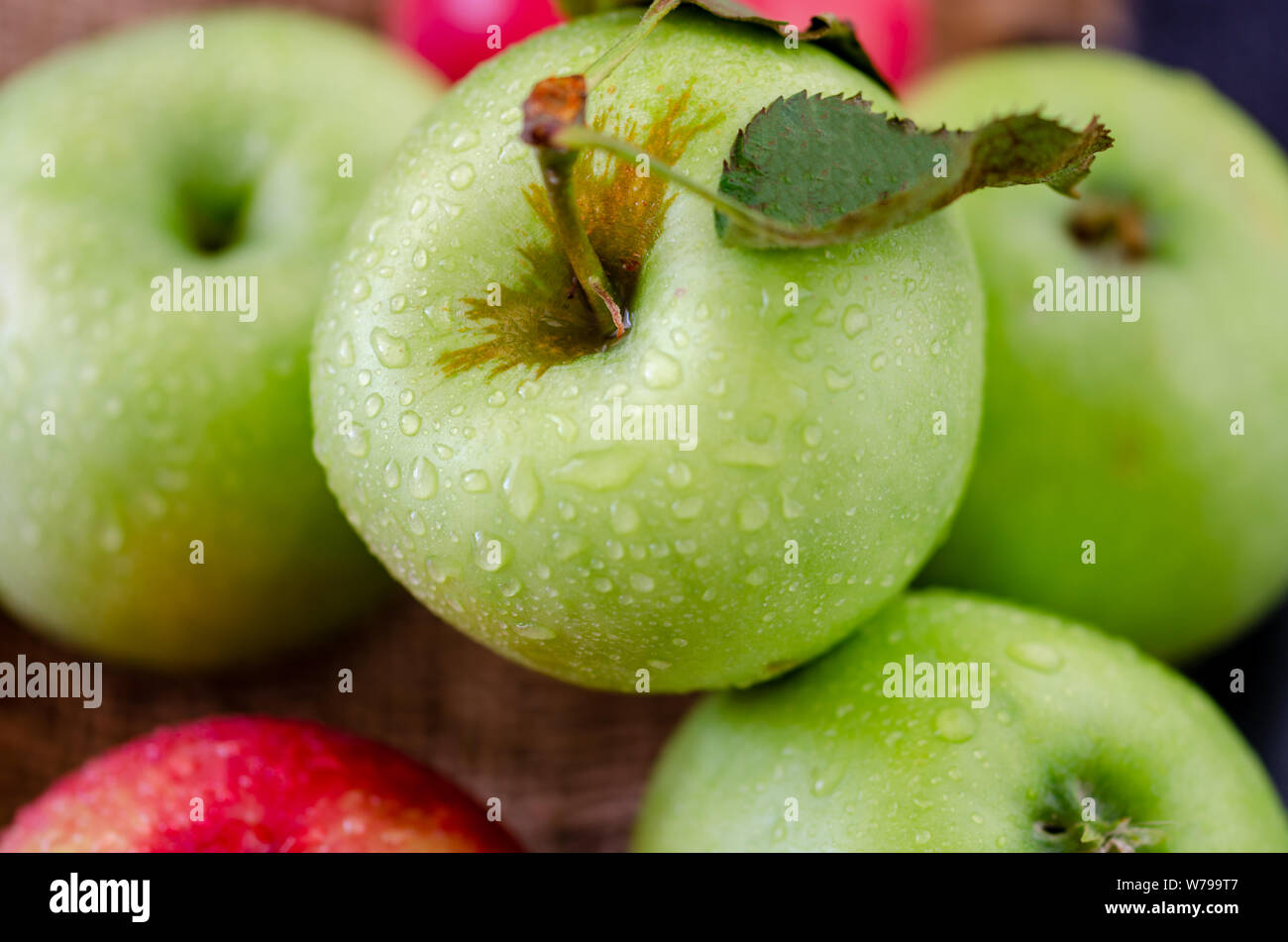 A group of different colors of apples on a black table. Horizontal and ...
