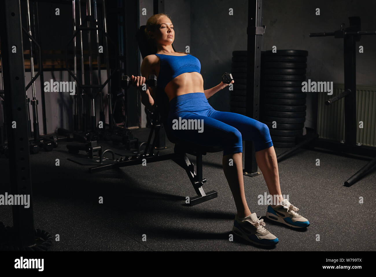 slim girl with perfect, ideal body is fond of sport. full length side ...