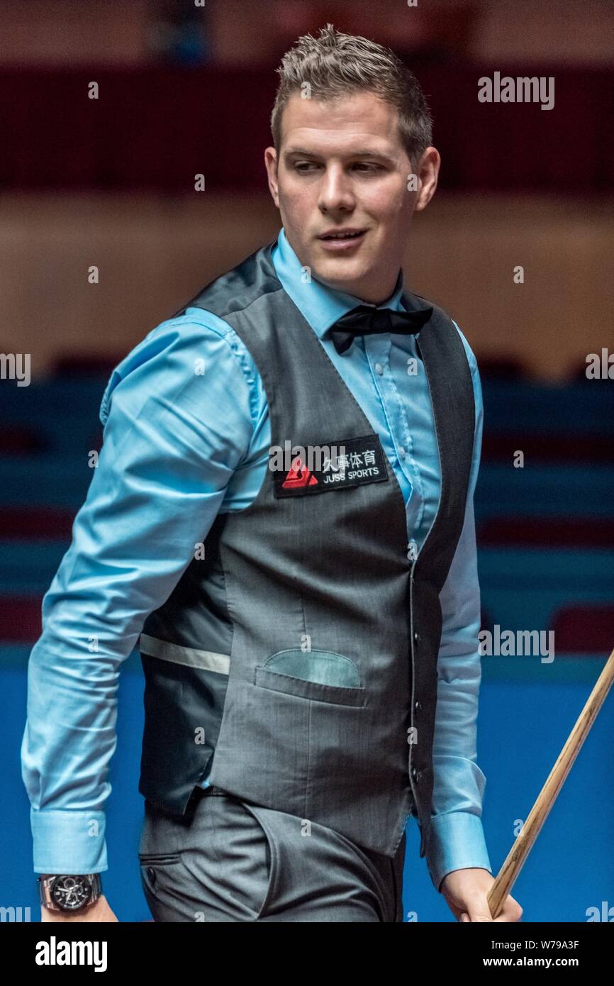 Barry Hawkins of England reacts as he considers a shot to Daniel Wells ...