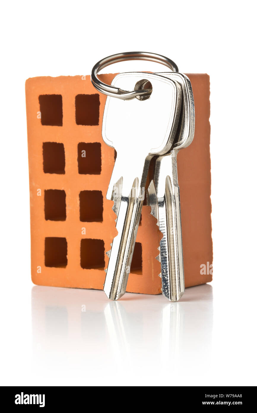 House keys on bricks over white background with selective focus - home ...