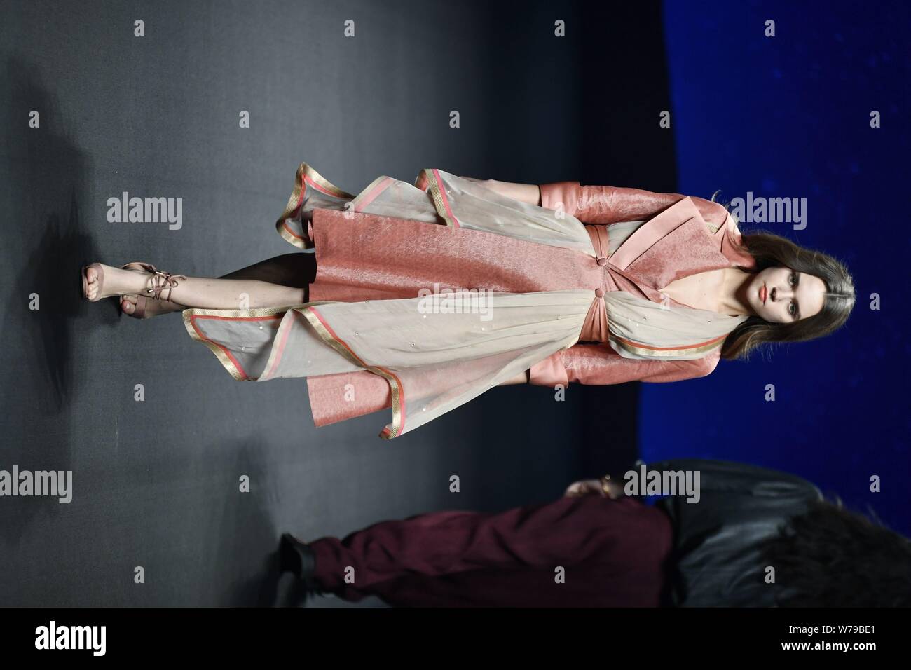 A model displays a new creation at the fashion show of Chuhetingxiang ...