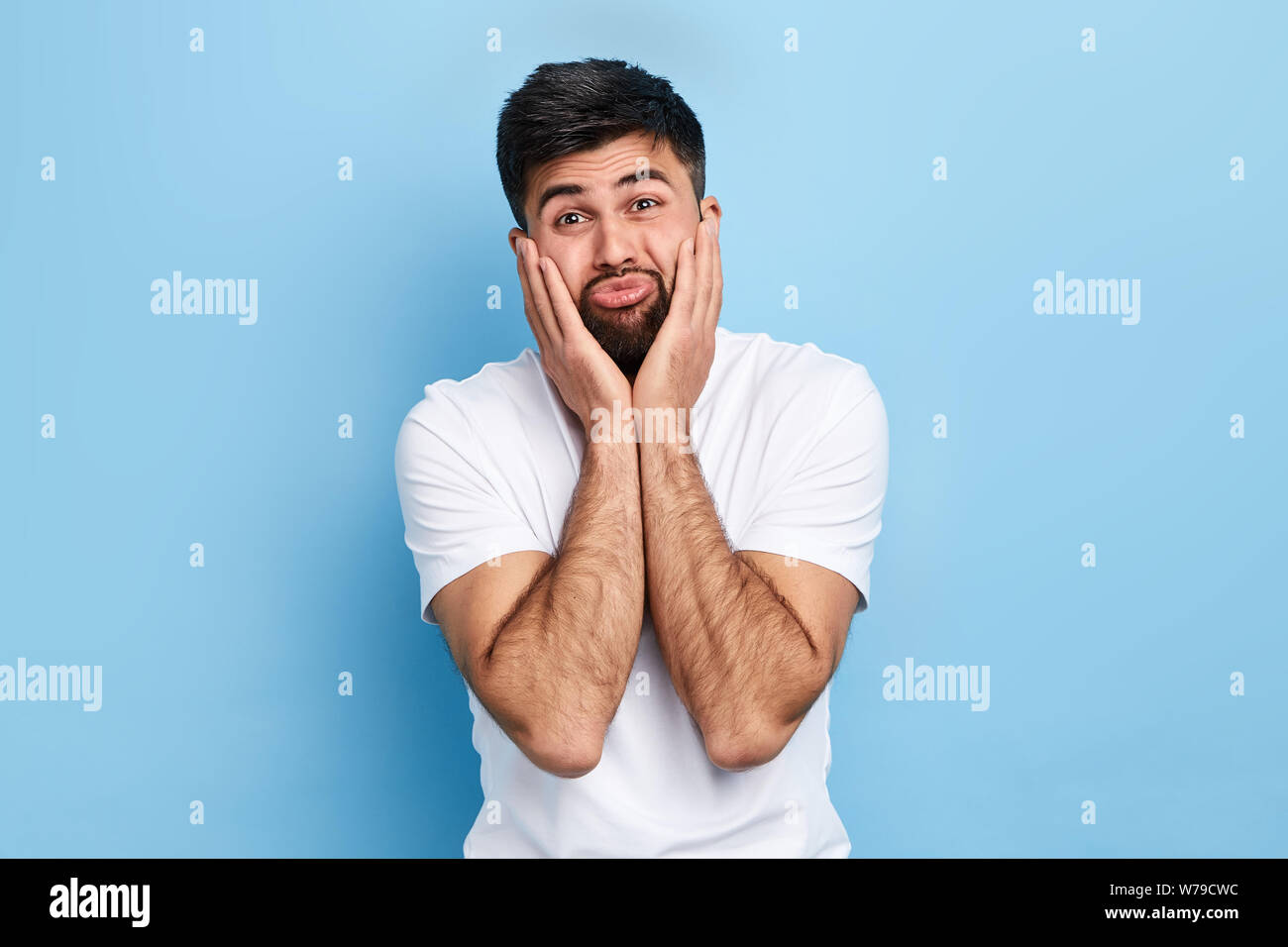 stressed,tired, crying handsome man squeezing cheeks with palms, being ...