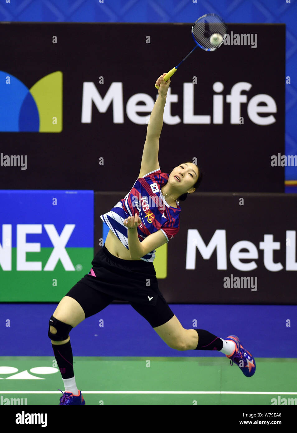 Sung Ji-hyun of South Korea returns a shot to Yip Pui Yin of Hong Kong ...
