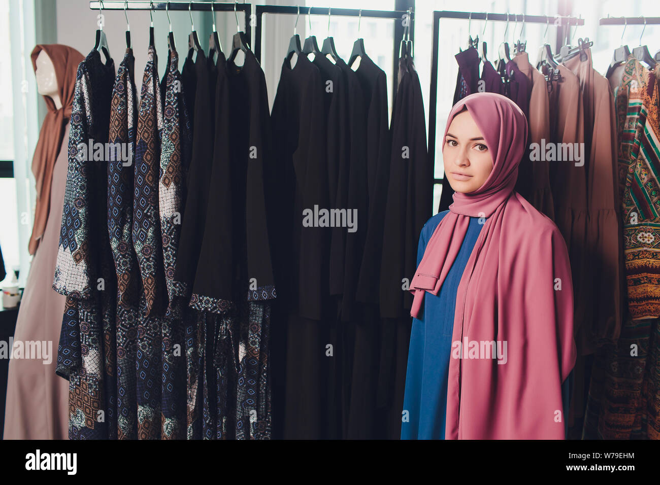 Arab woman in traditional Muslim clothes buys a new dress in an ...