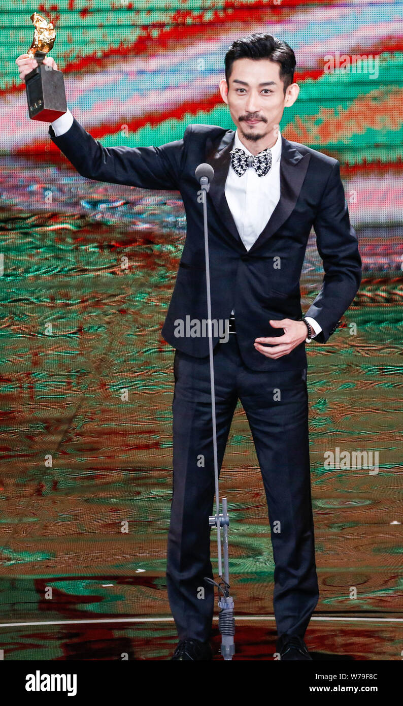 **TAIWAN OUT**Taiwanese actor Chen Chu-sheng holds up his trophy of the ...